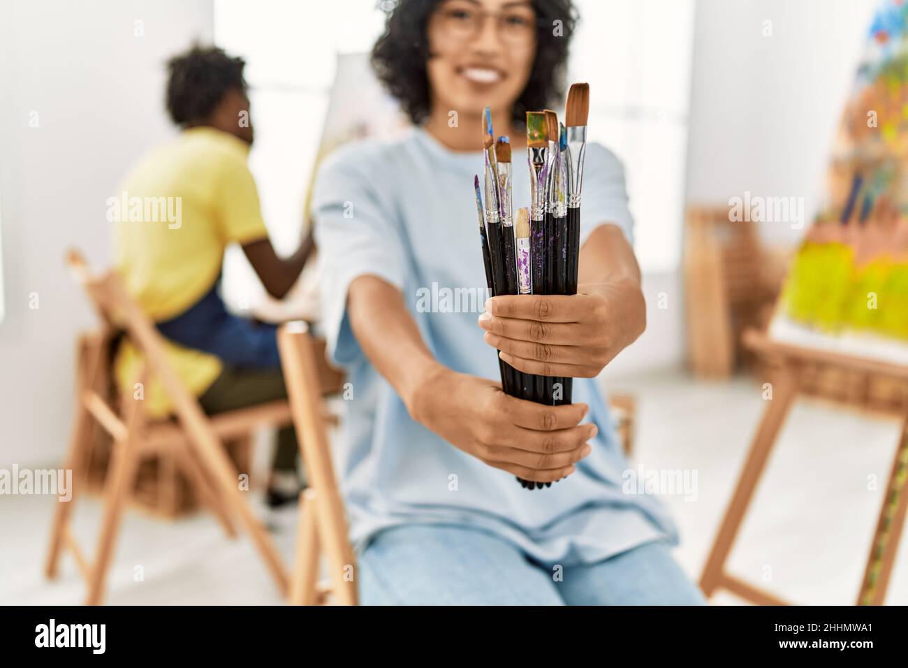 African american artist couple smiling happy painting at art studio ...