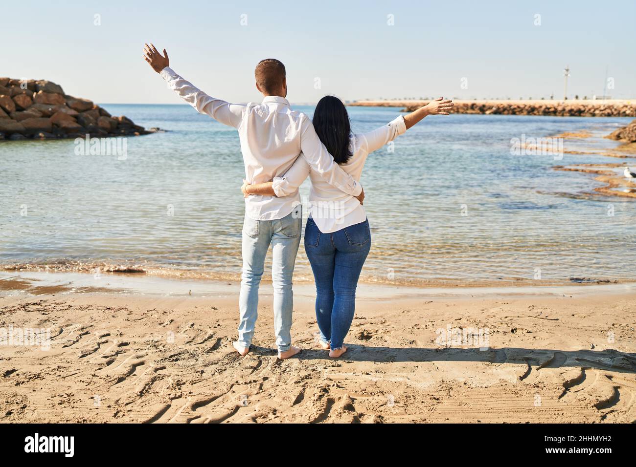 Man And Woman Couple On Back View Hugging Each Other Standing At