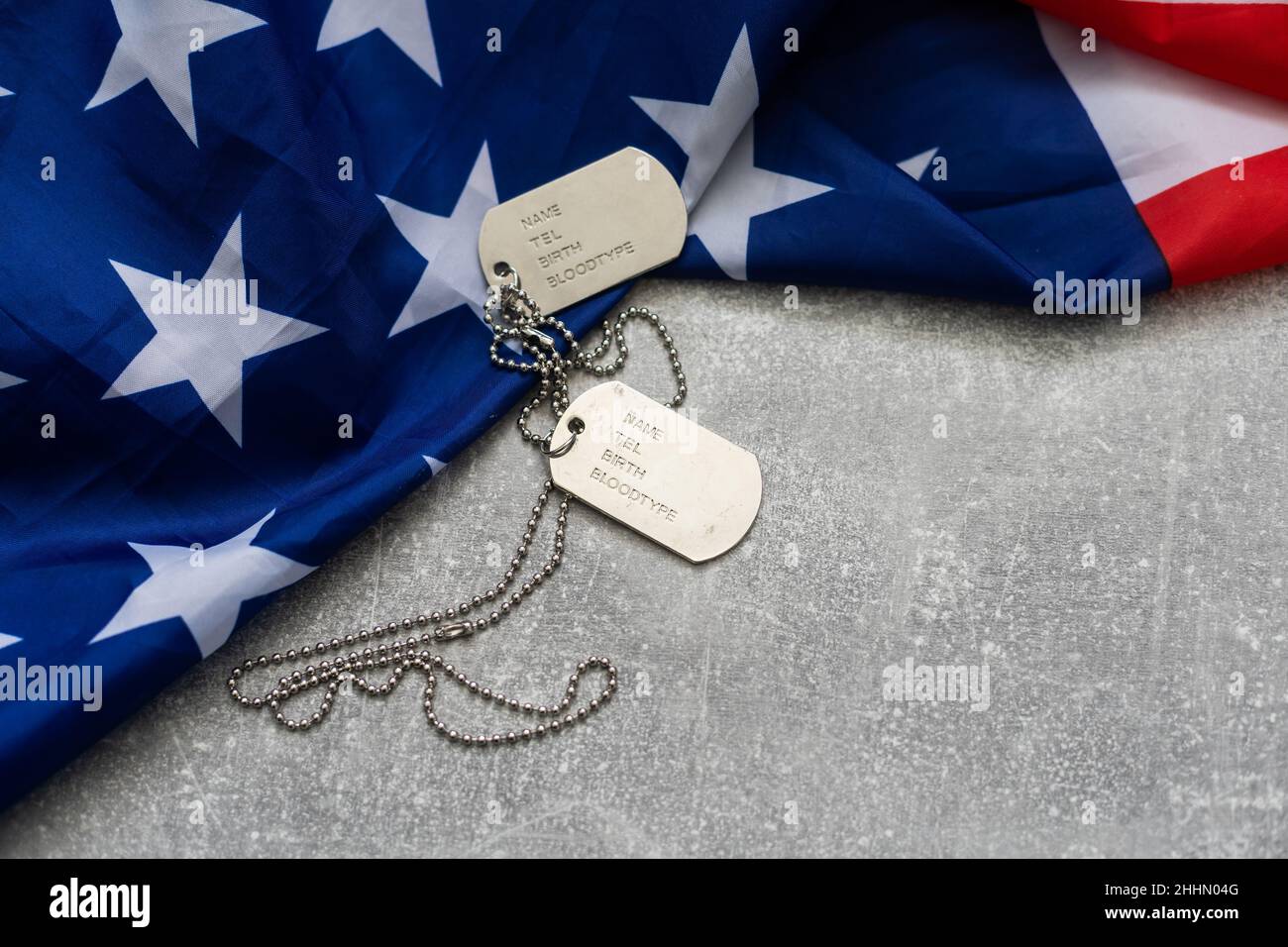 Authentic military dog tag on an american flag Stock Photo - Alamy