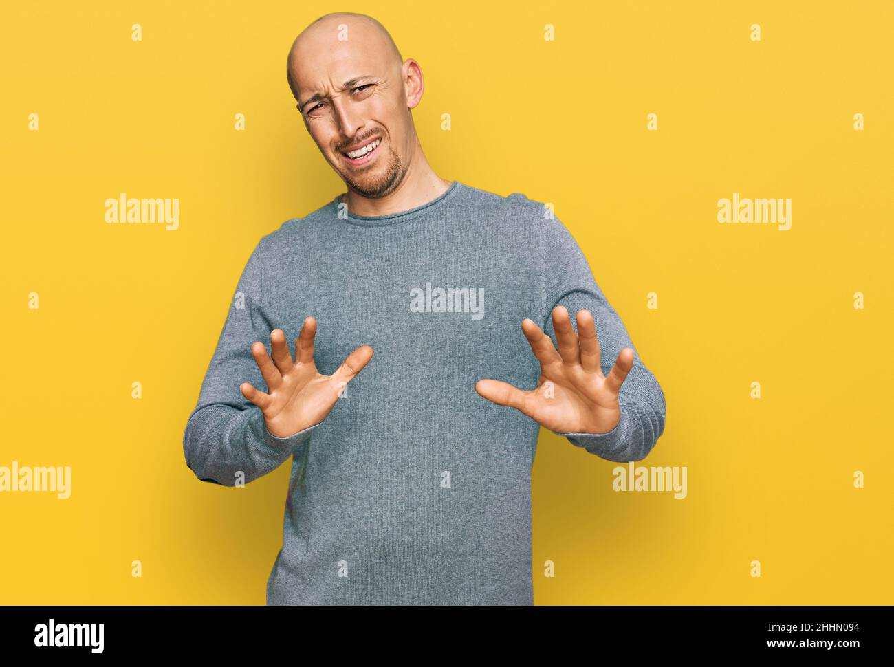 Bald man with beard wearing casual clothes disgusted expression ...
