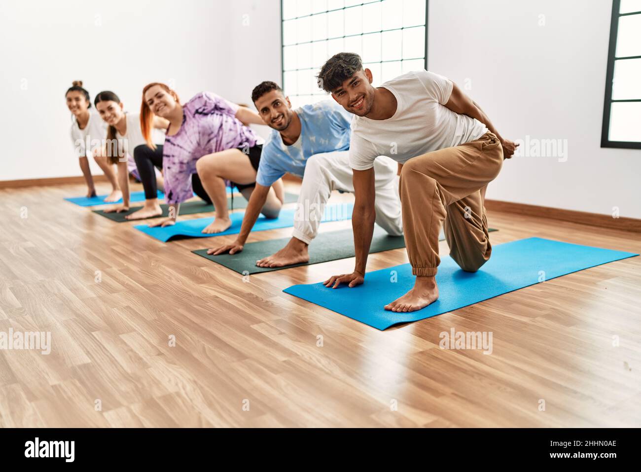 Group of young people smiling happy training yoga at sport center Stock ...