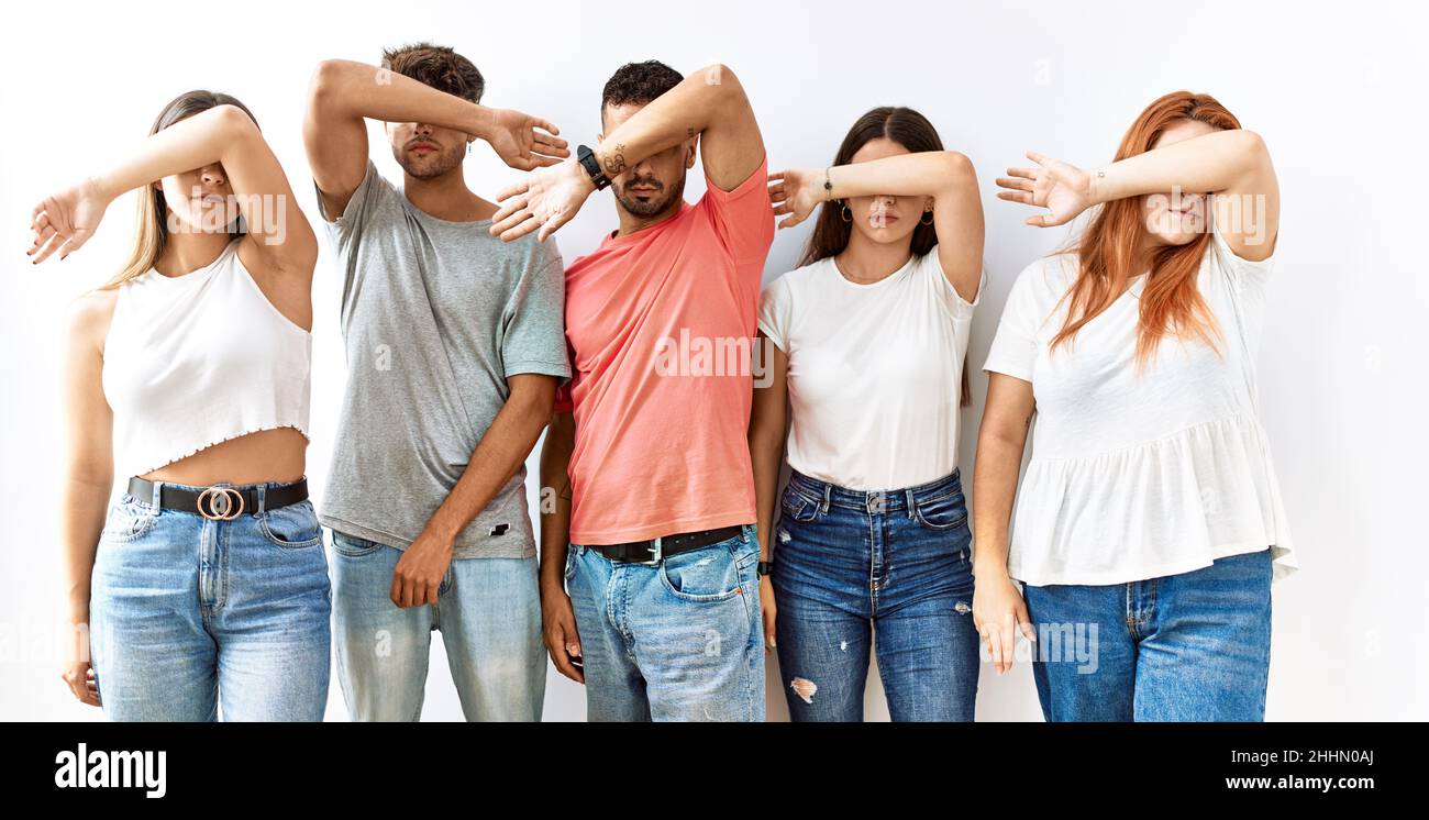 Group of young friends standing together over isolated background ...