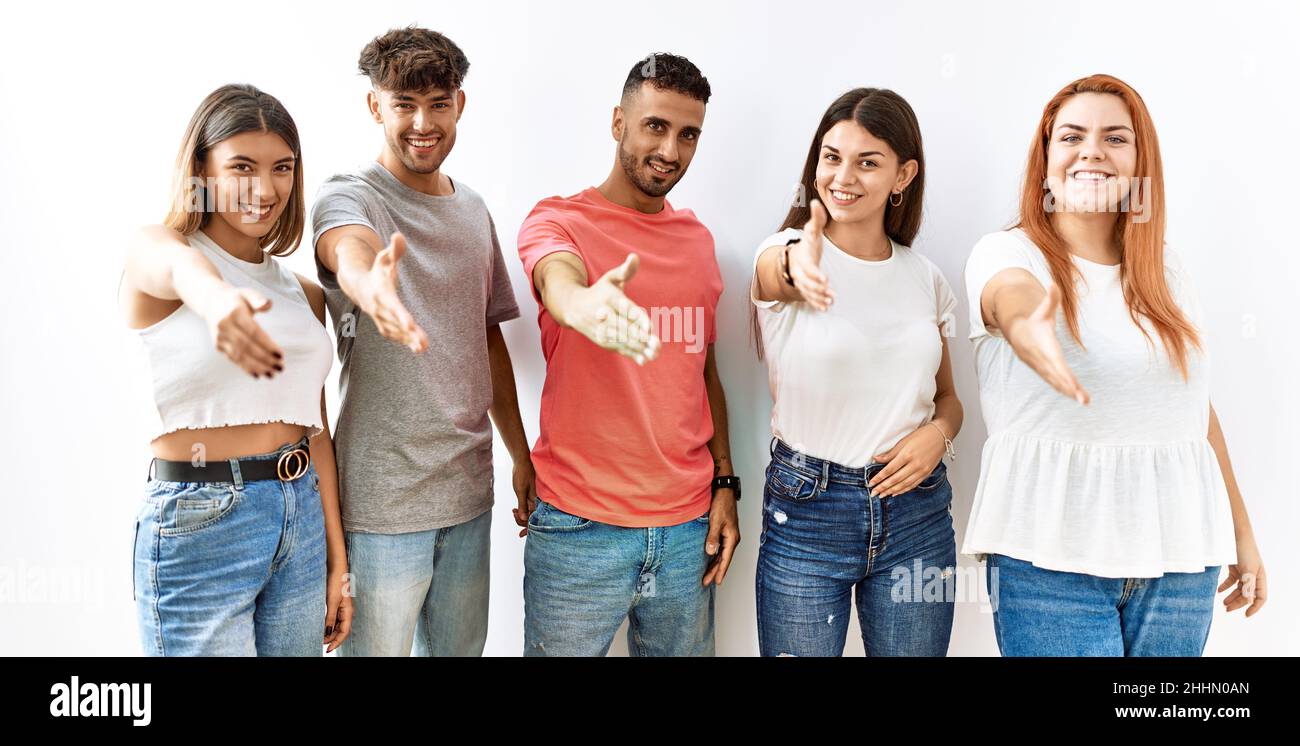 Group of young friends standing together over isolated background ...
