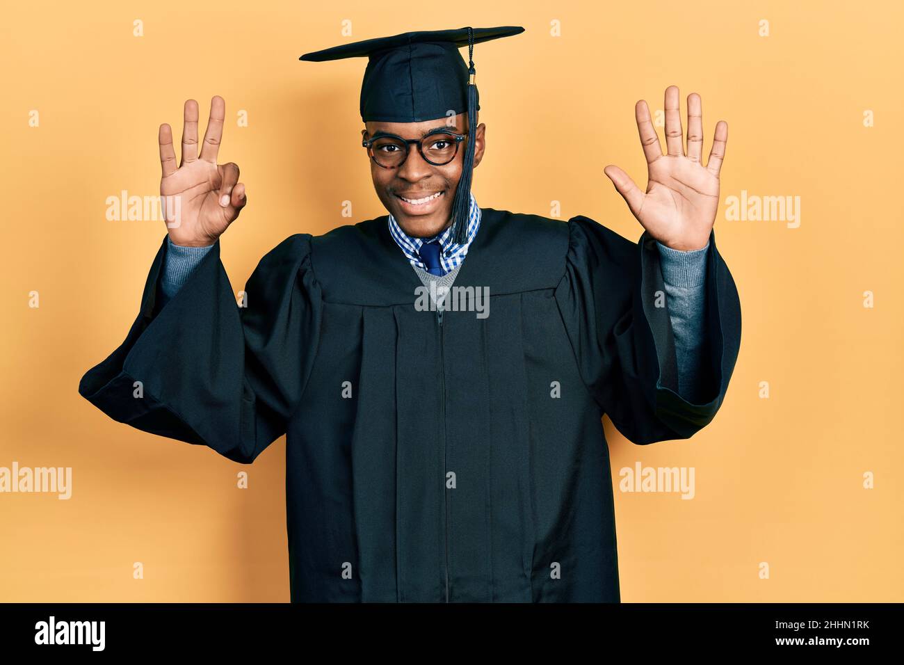 Young african american man wearing graduation cap and ceremony robe ...