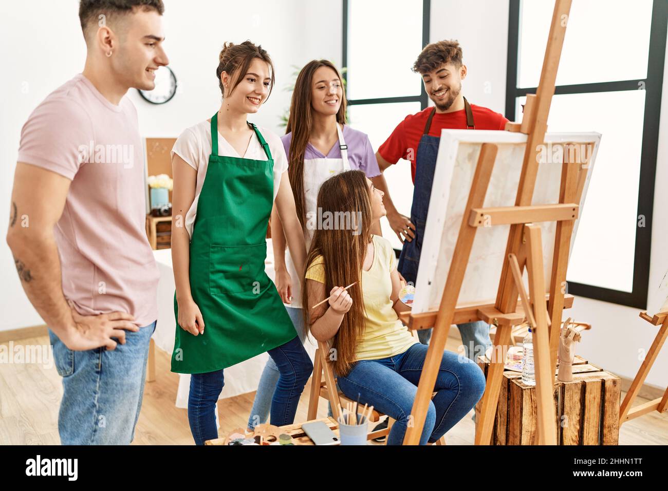 Group of people smiling happy and looking draw of partner at art studio ...