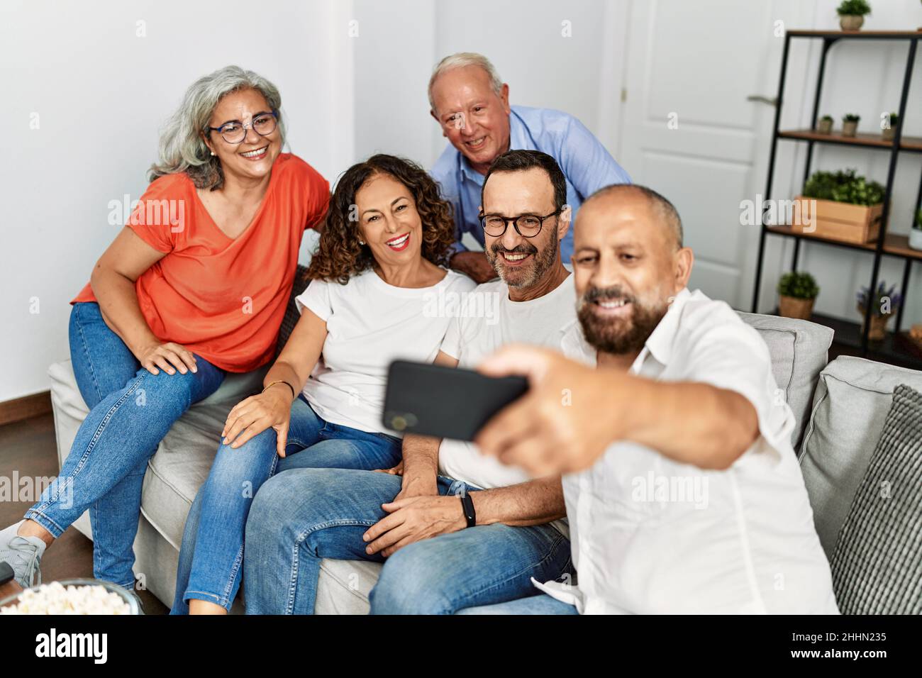 Group of middle age friends smiling happy make selfie by the smartphone ...