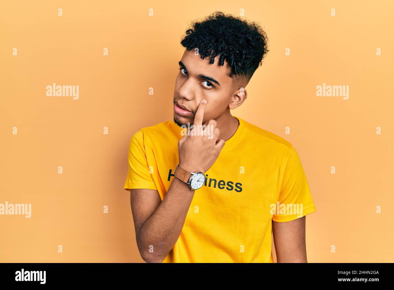 Young african american man wearing t shirt with happiness word message ...