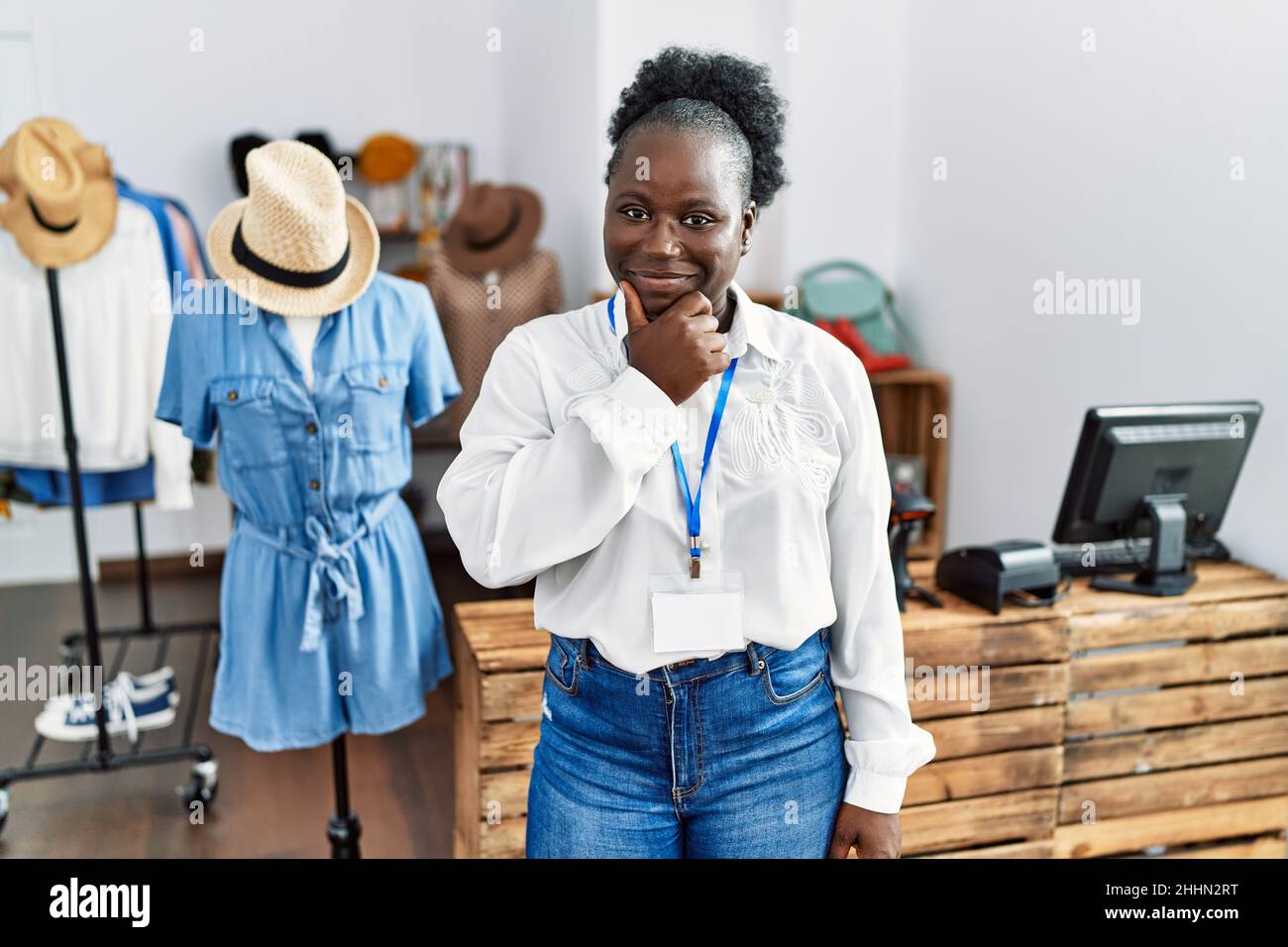 Young african woman working as manager at retail boutique looking ...
