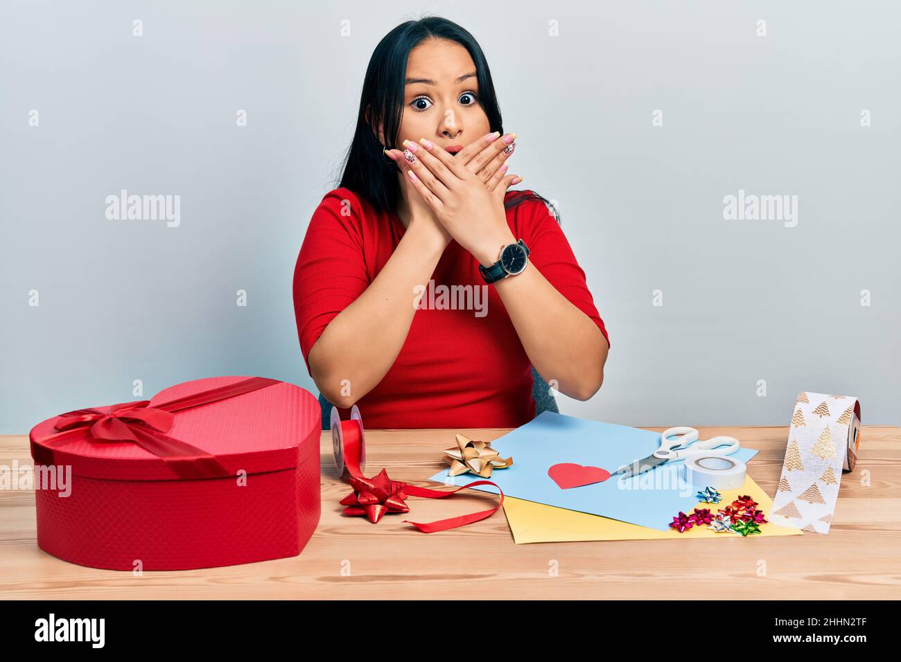 Beautiful hispanic woman with nose piercing doing handcraft creative ...
