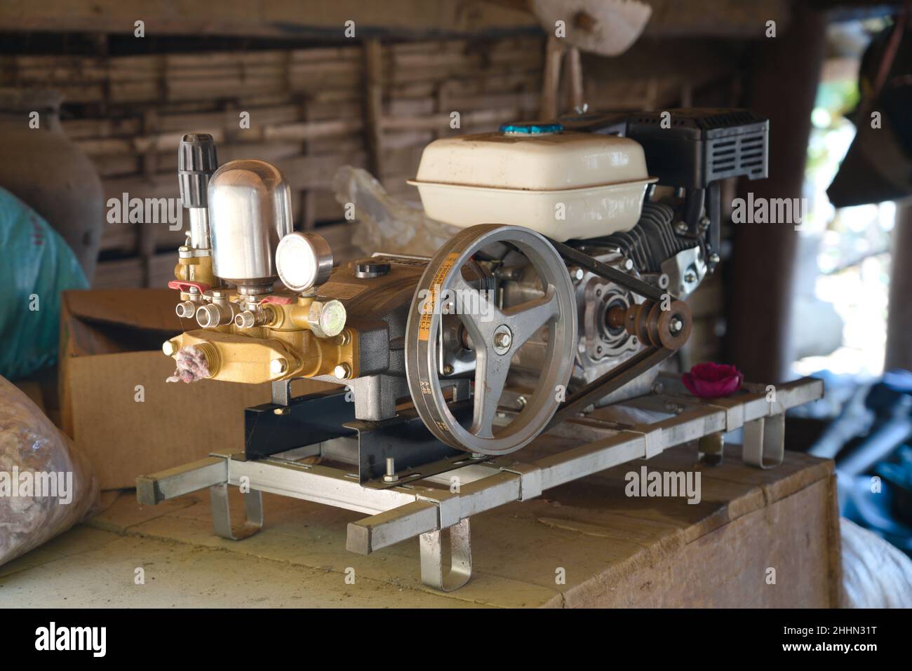 Agriculture machine under the house Stock Photo - Alamy
