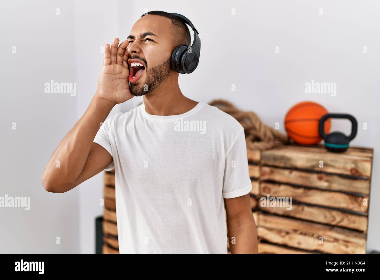 African american man listening to music using headphones at the gym ...