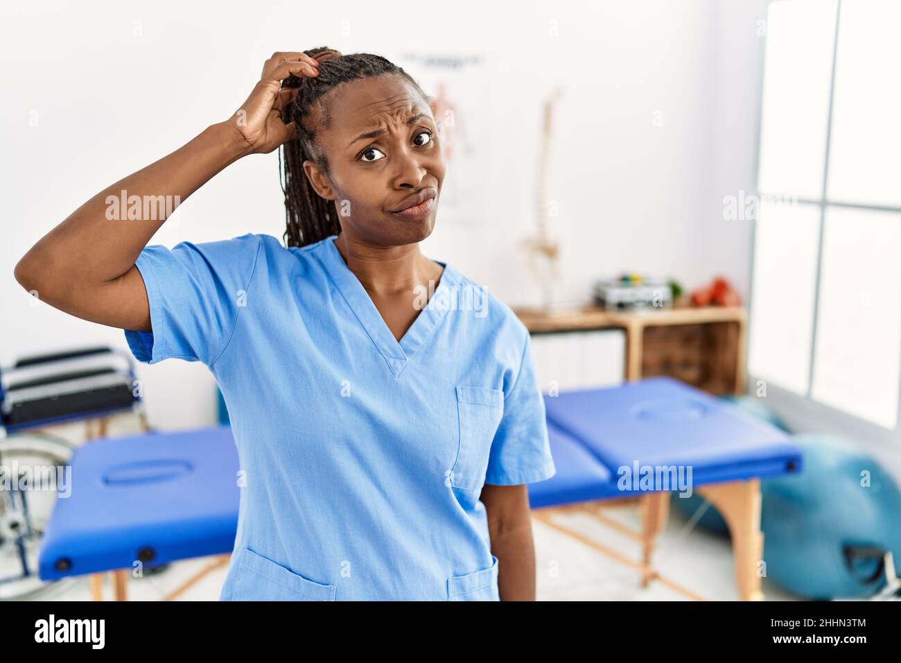 Black woman with braids working at pain recovery clinic confuse and ...