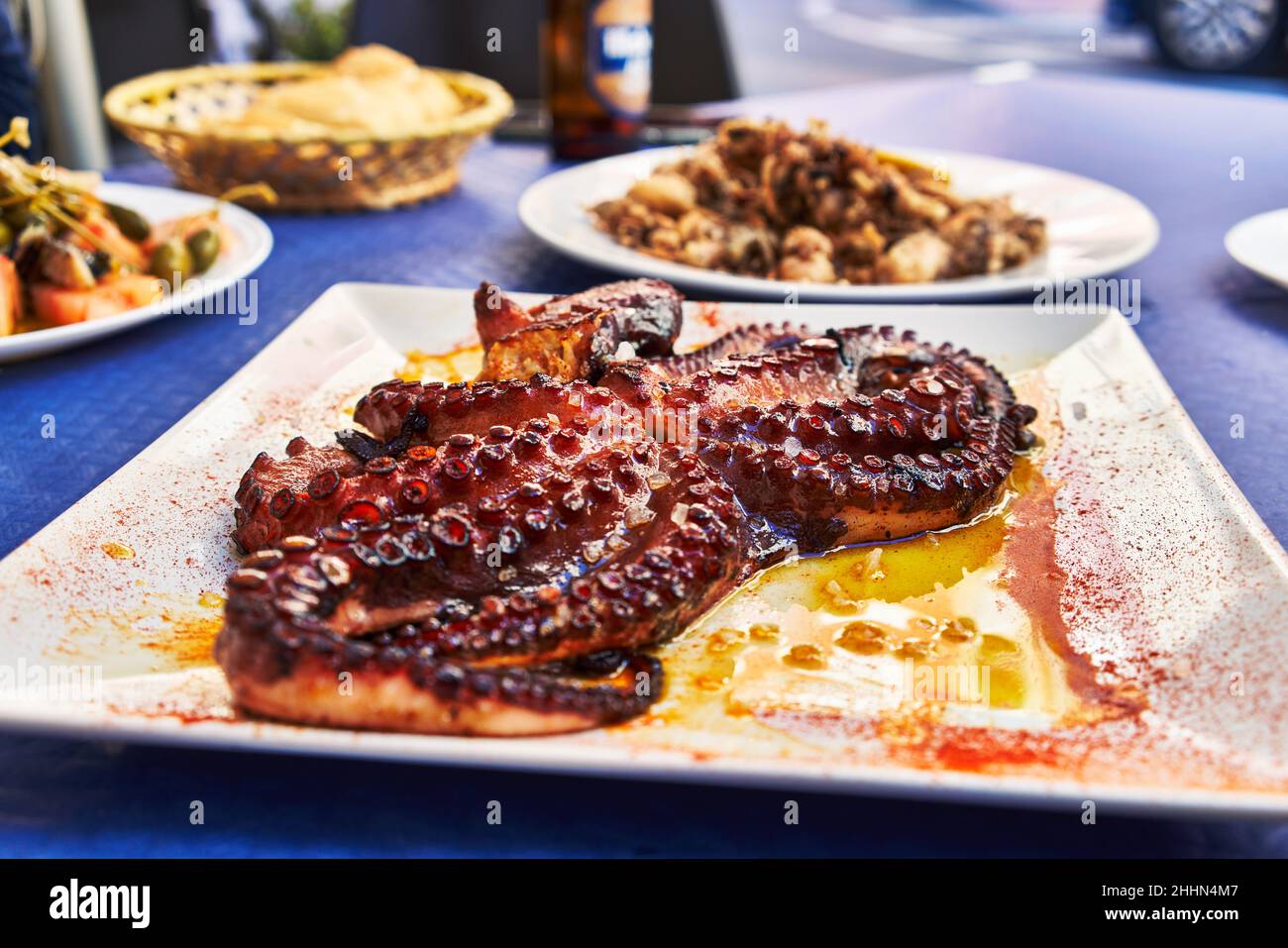 Plate of octopus on paper surface Stock Photo - Alamy