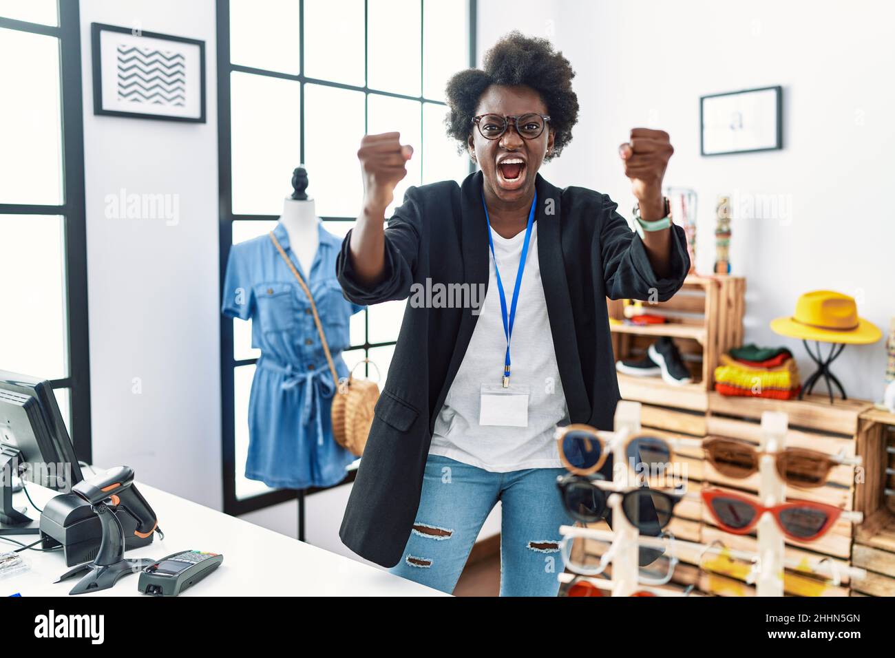 African young woman working as manager at retail boutique angry and mad ...