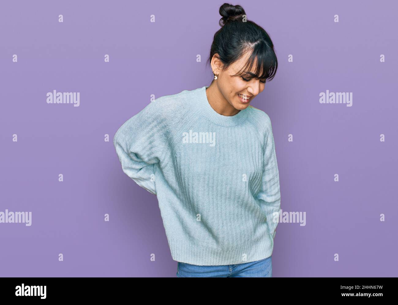Young hispanic woman wearing casual clothes suffering of backache ...