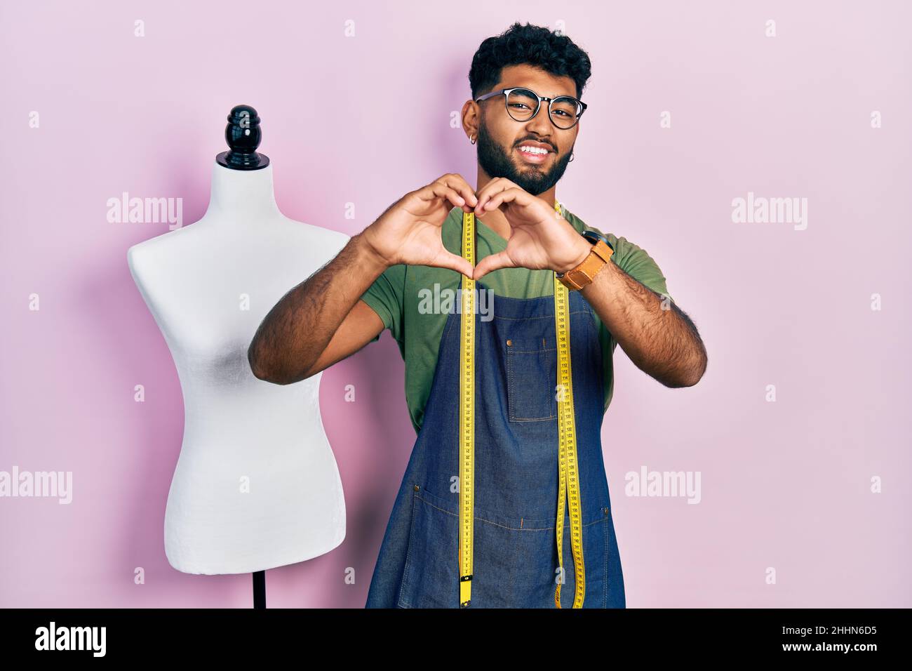 Arab man with beard dressmaker designer wearing atelier apron smiling ...