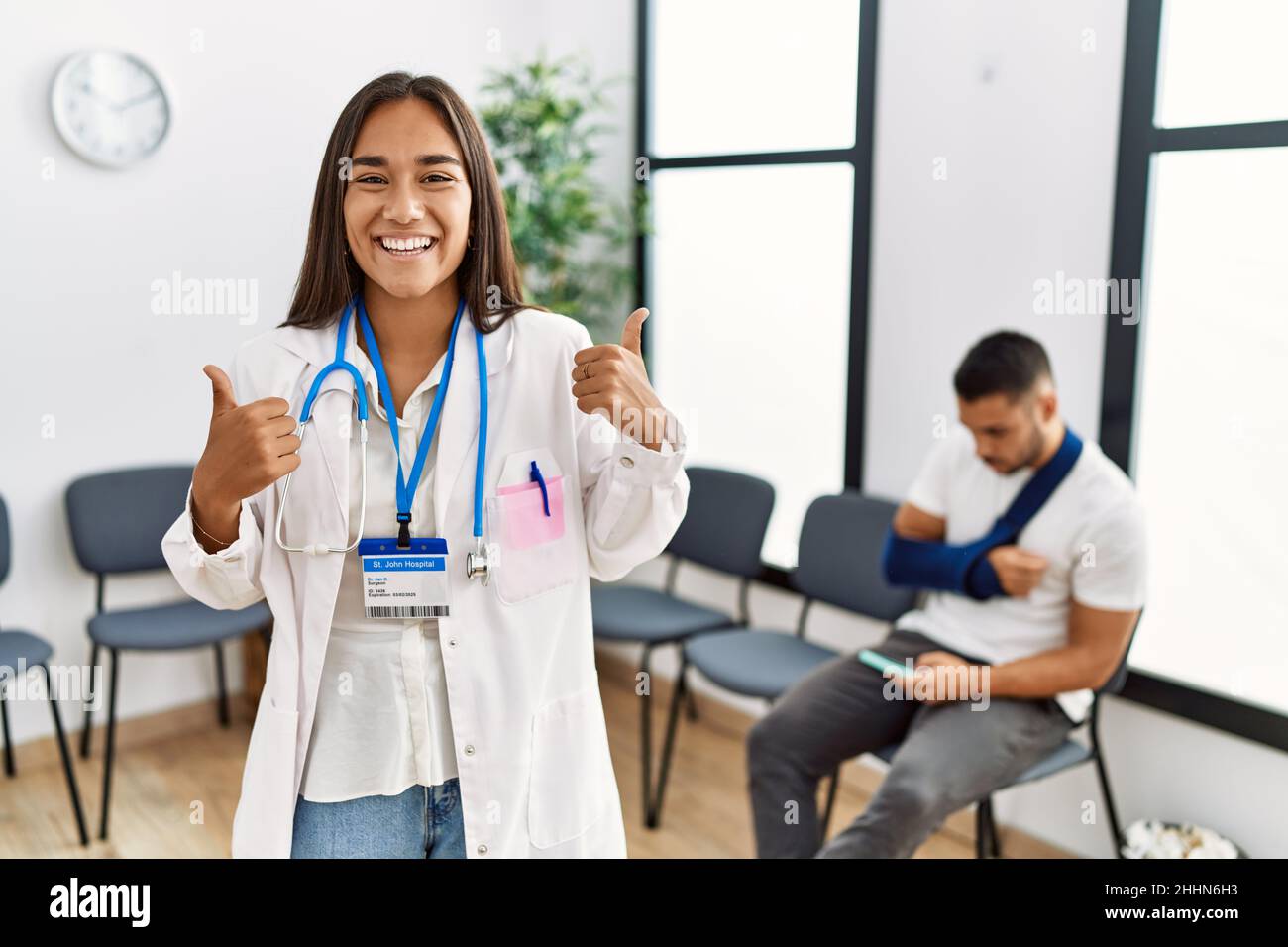 Young asian doctor woman at waiting room with a man with a broken arm ...