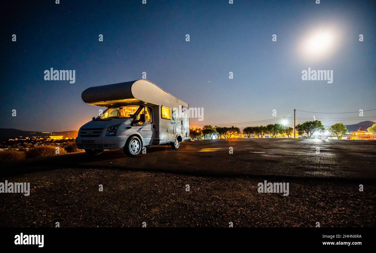 Motorhome RV parked under stars on a pier by the sea, Crete, Greece ...