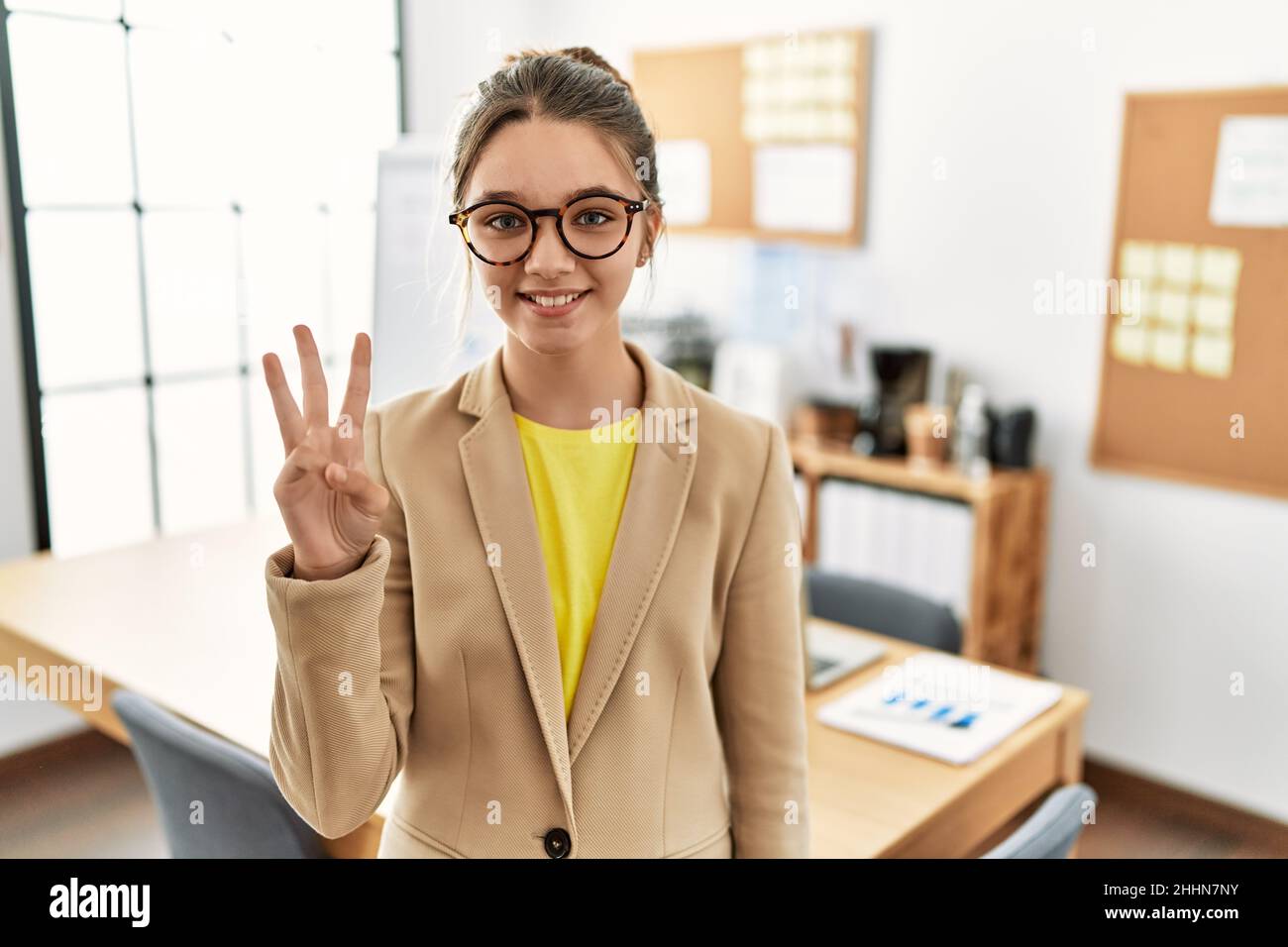 Young brunette teenager wearing business style at office showing and ...