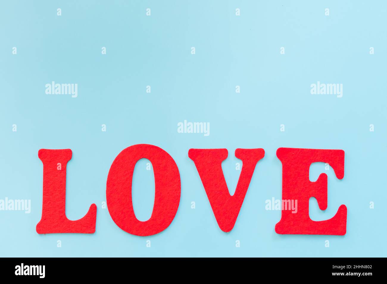 Love text on blue background with copy space Stock Photo - Alamy