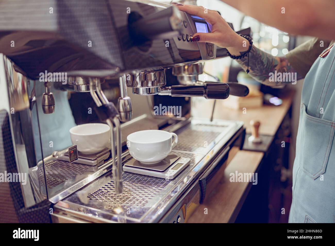 Female barista using coffee machine in cafeteria Stock Photo - Alamy