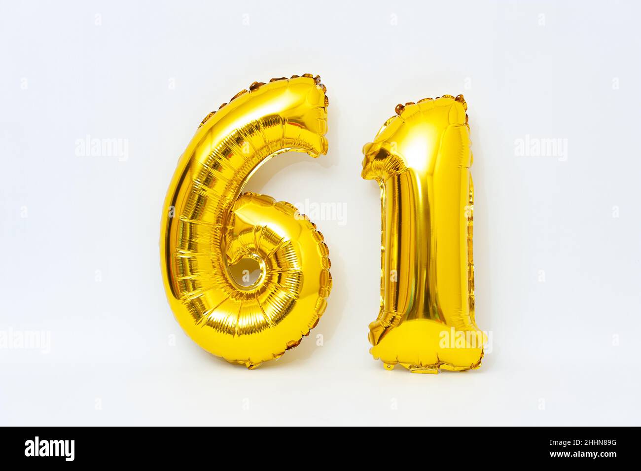 Inflatable numeral 61 sparkling metallic golden color isolated on white ...