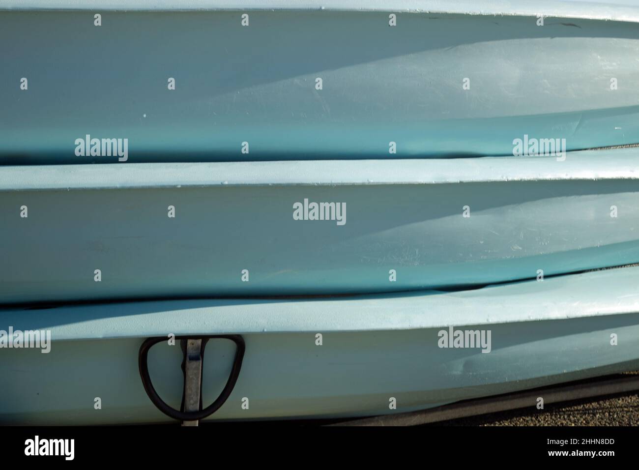 Three stacked light blue canoes shot close up in landscape format Stock ...