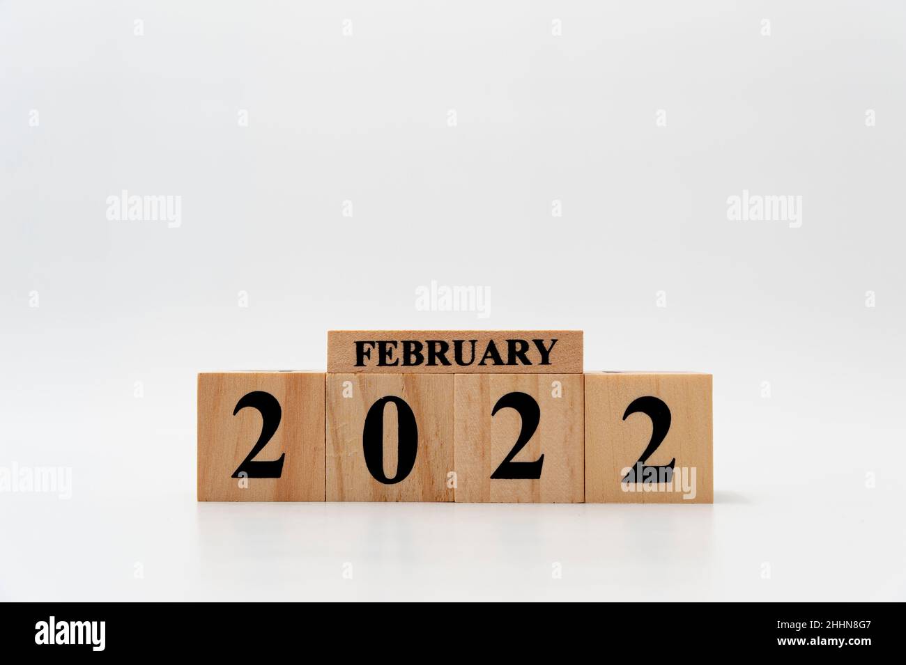 February 2022 written on wooden blocks isolated on white background ...