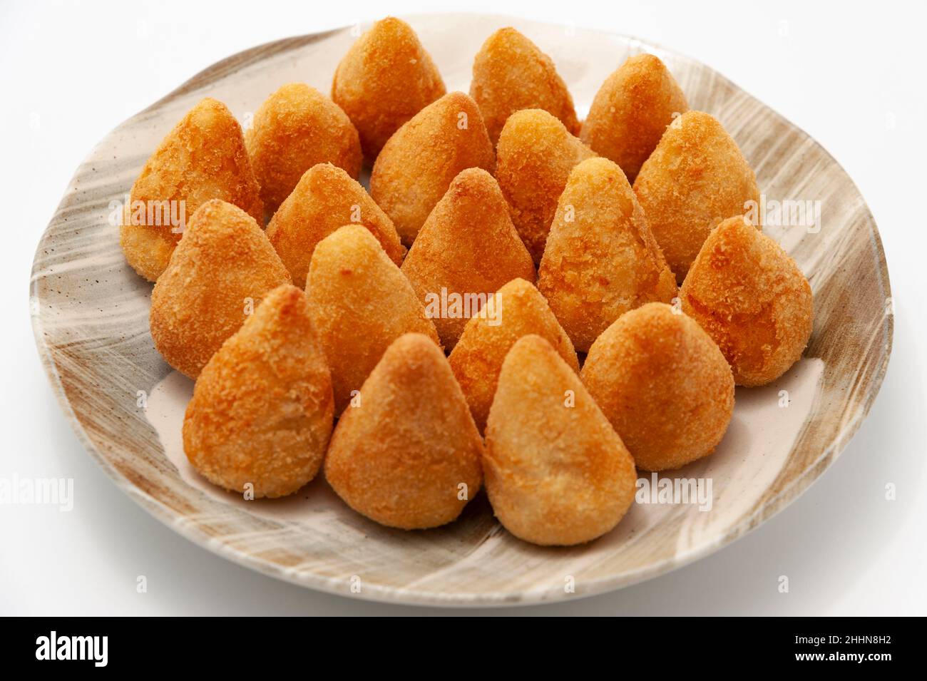 Typical Brazilian appetizer called Coxinha de Frango isolated on white ...