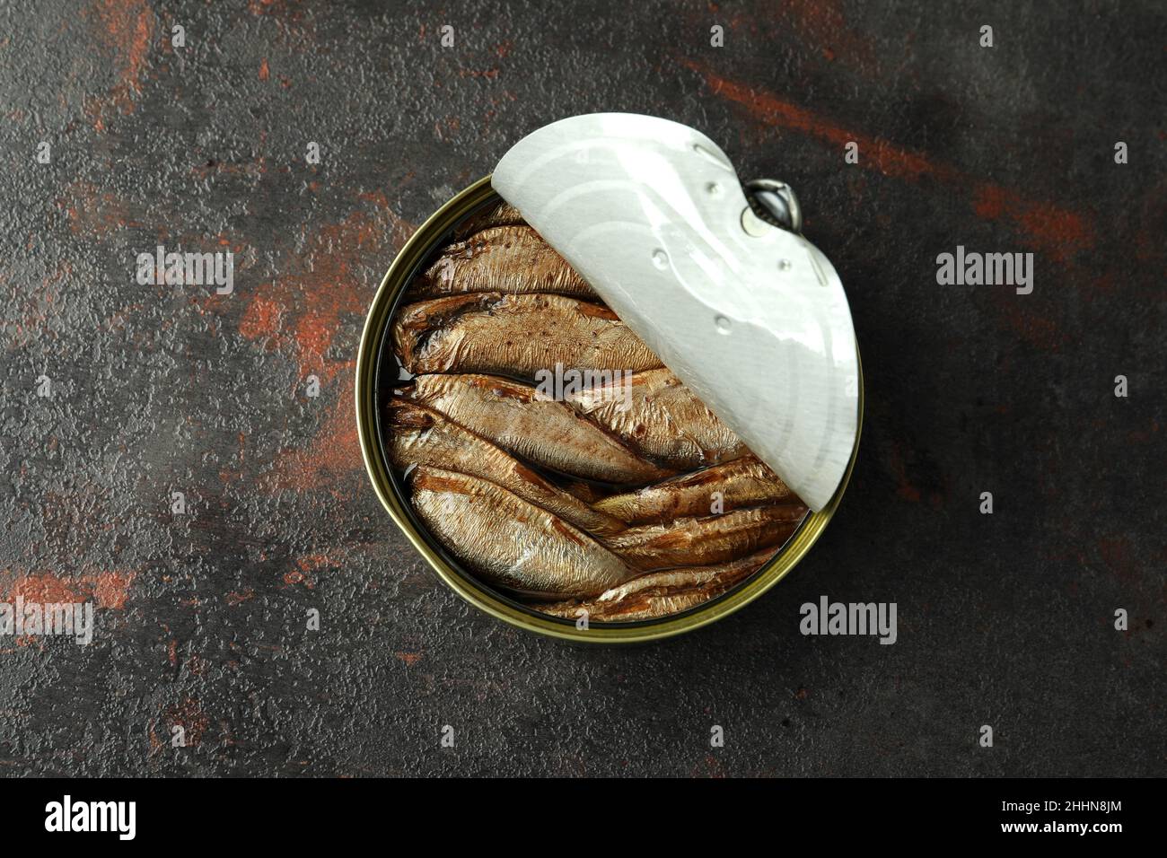 Tin can of sprats on textured background Stock Photo - Alamy