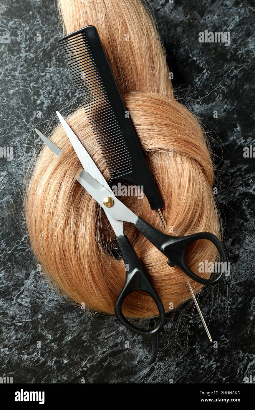 Female hair with scissors and hairbrush on dark background Stock Photo ...