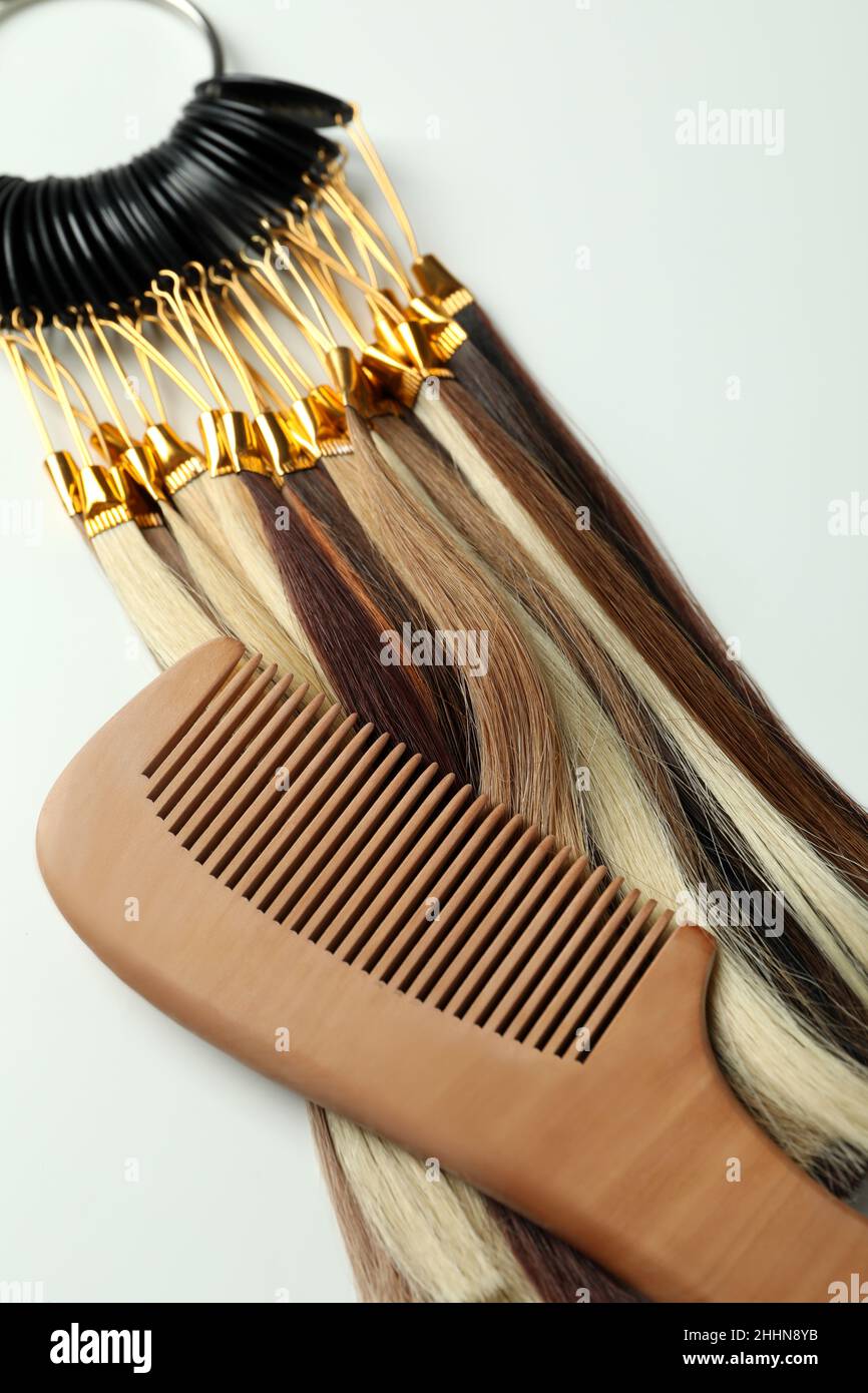 Hair samples and hairbrush on white background Stock Photo - Alamy