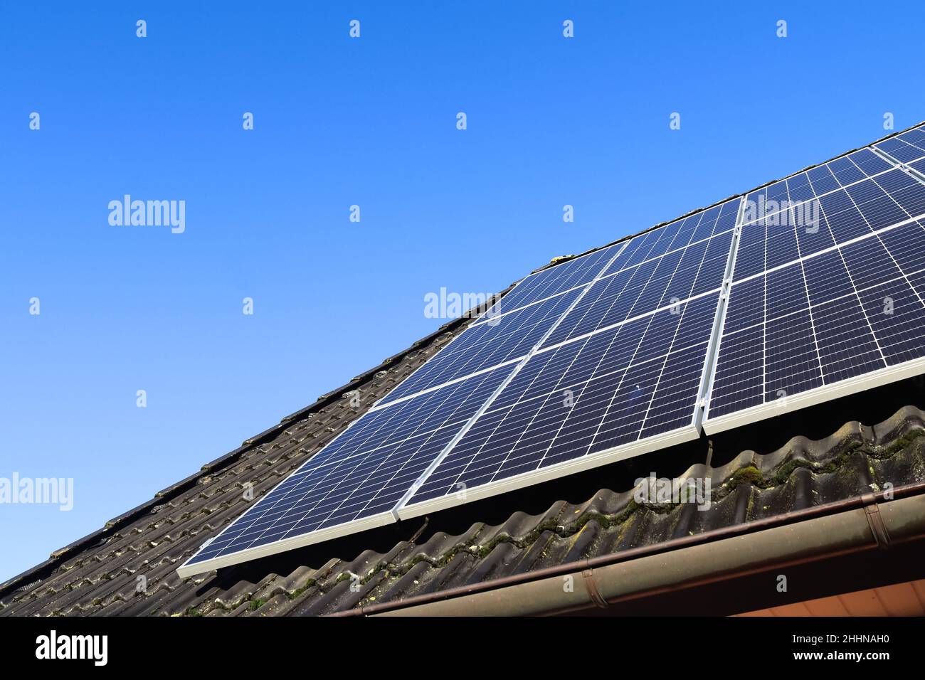 Solar panels producing clean energy on a roof of a residential house ...