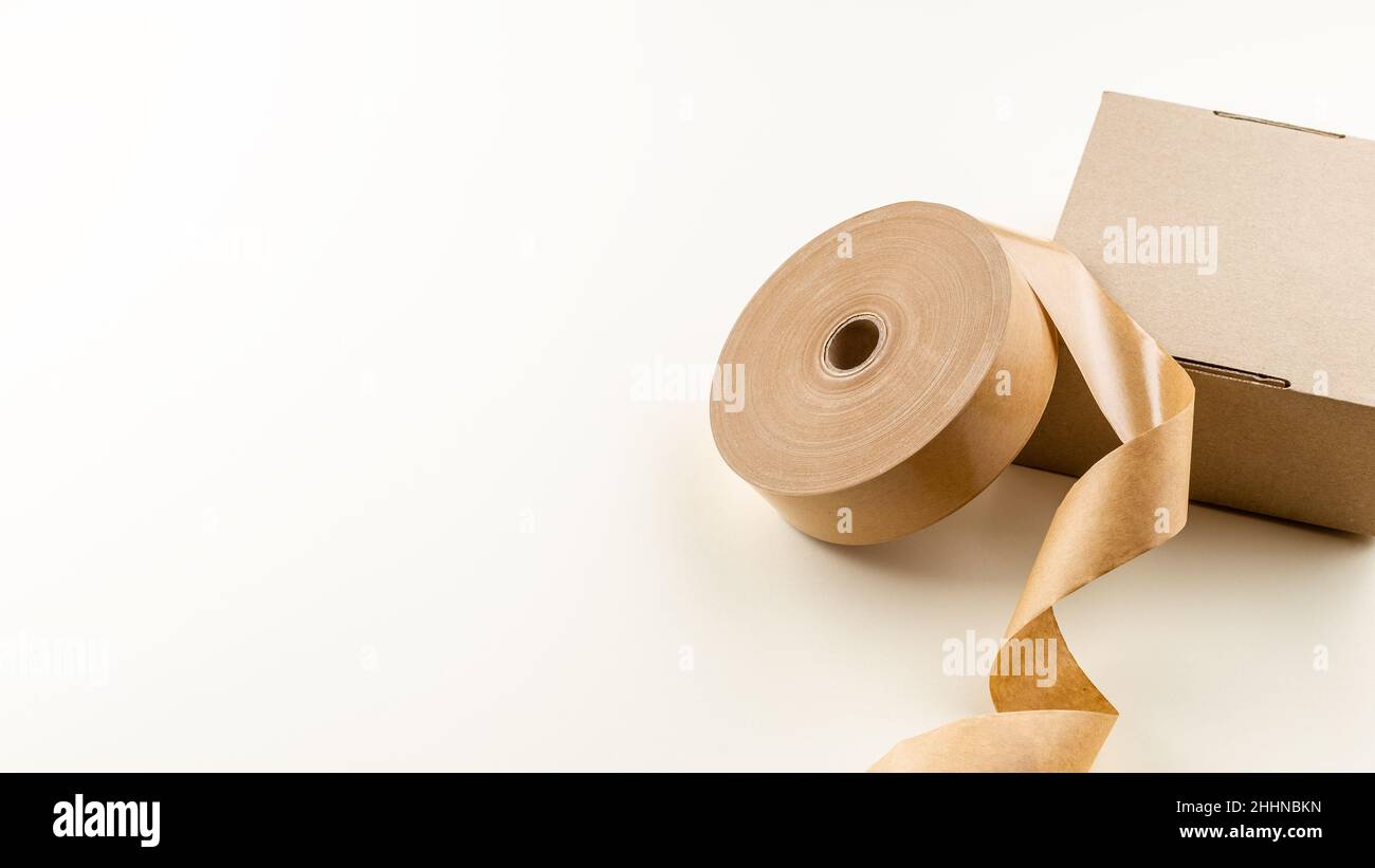The roll of biodegradable sticky tape made of paper and cardboard box ...