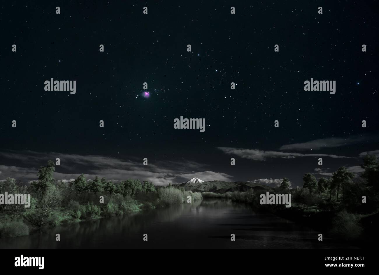 Infrared nightscape scenery of orion nebula over a mountain and a river ...