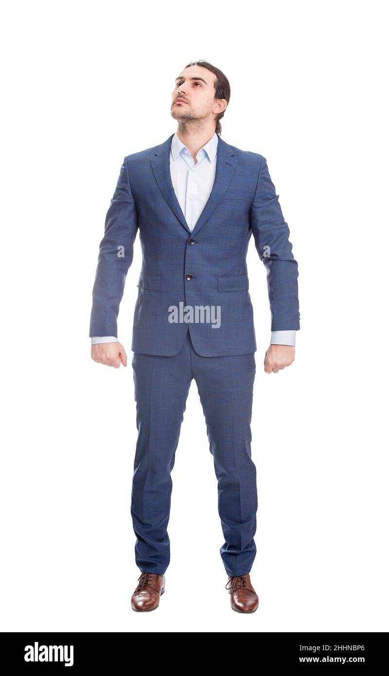 Determined businessman stands confident in a hero stance, full length ...