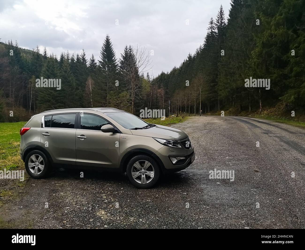 car standing alone on a parking place in the mountains with rain clouds ...