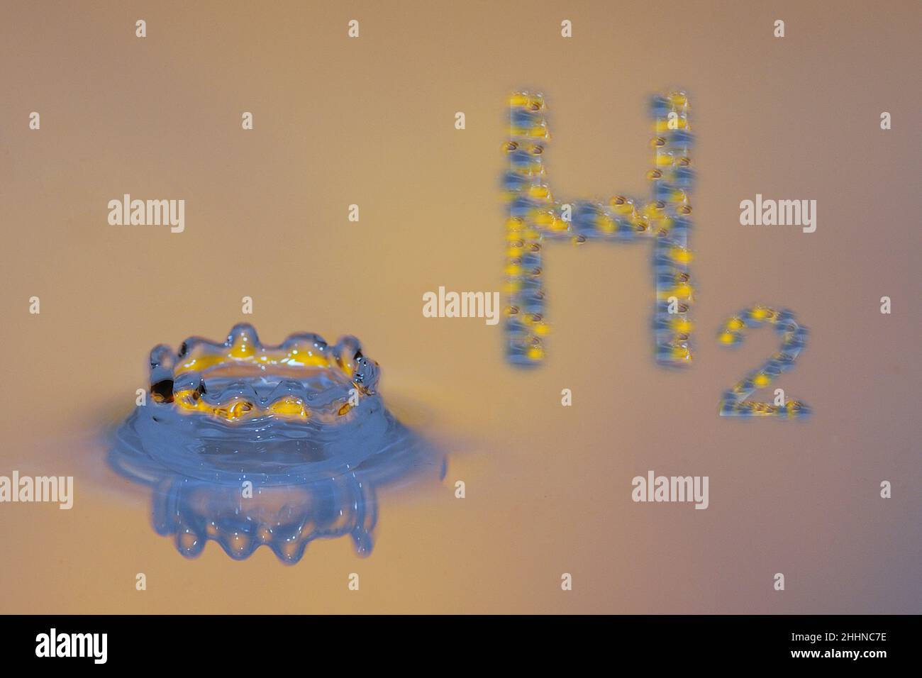 drop impact with orange background an hydrogen letters h2 energy of the ...