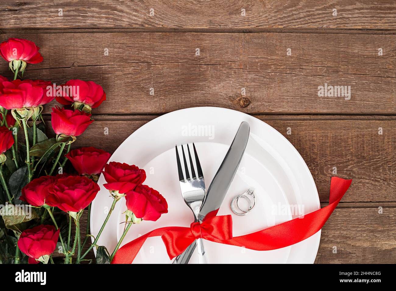 Valentines Day Dinner Table Setting With Red Ribbon Roses Knife And
