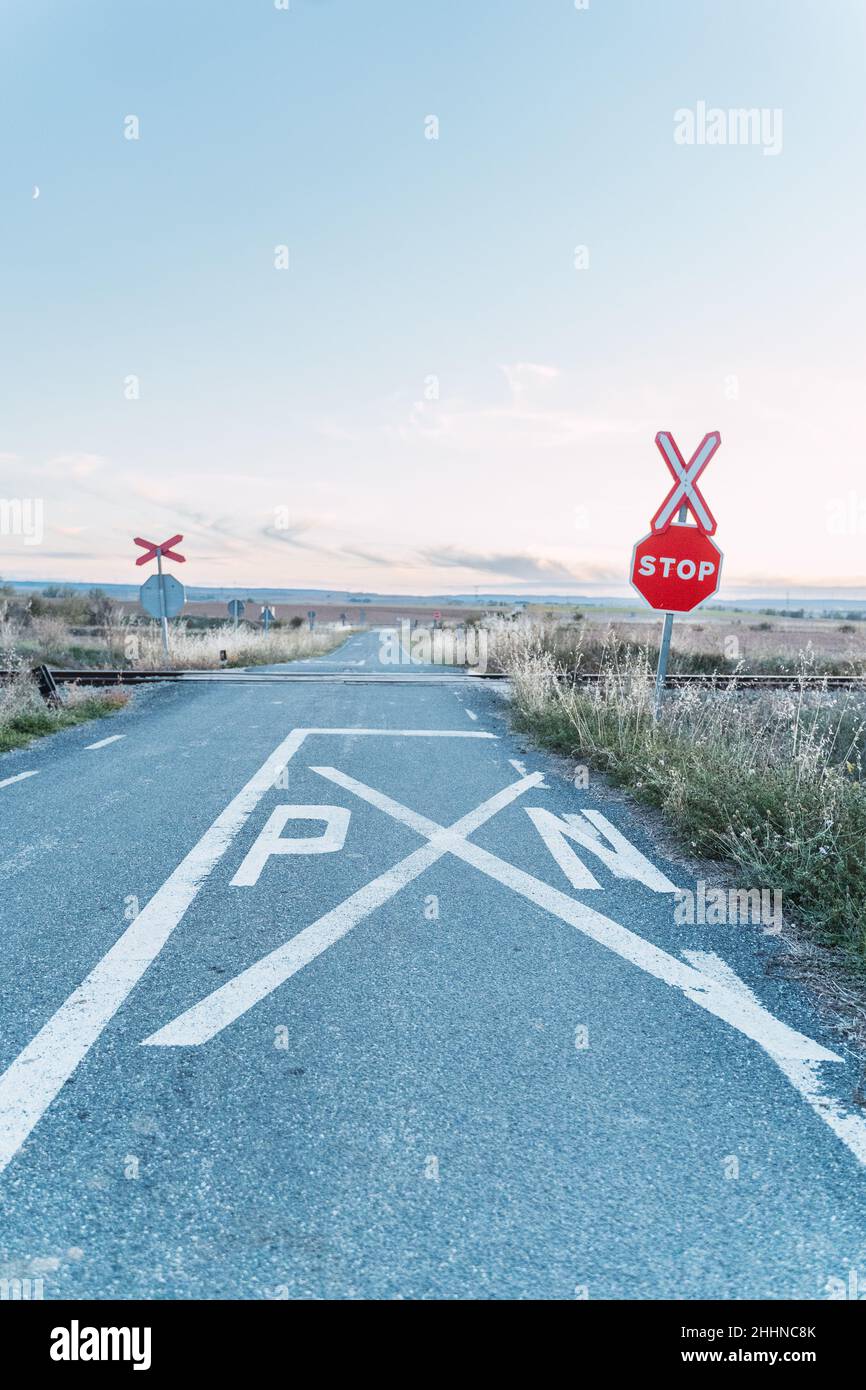 train tracks crossing a road Stock Photo - Alamy