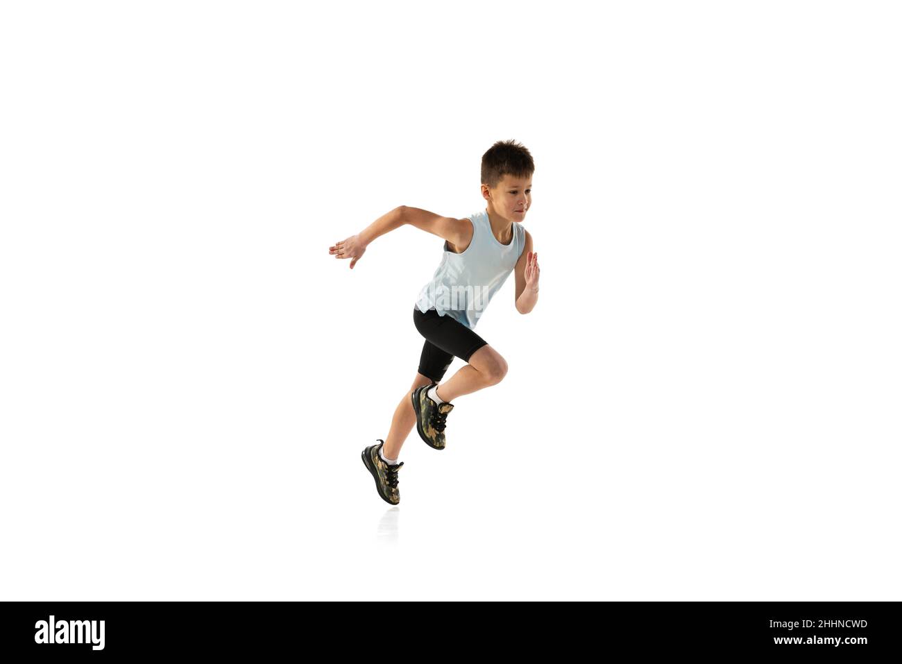 Side view studio portrait of boy, teenager in motion, running isolated ...