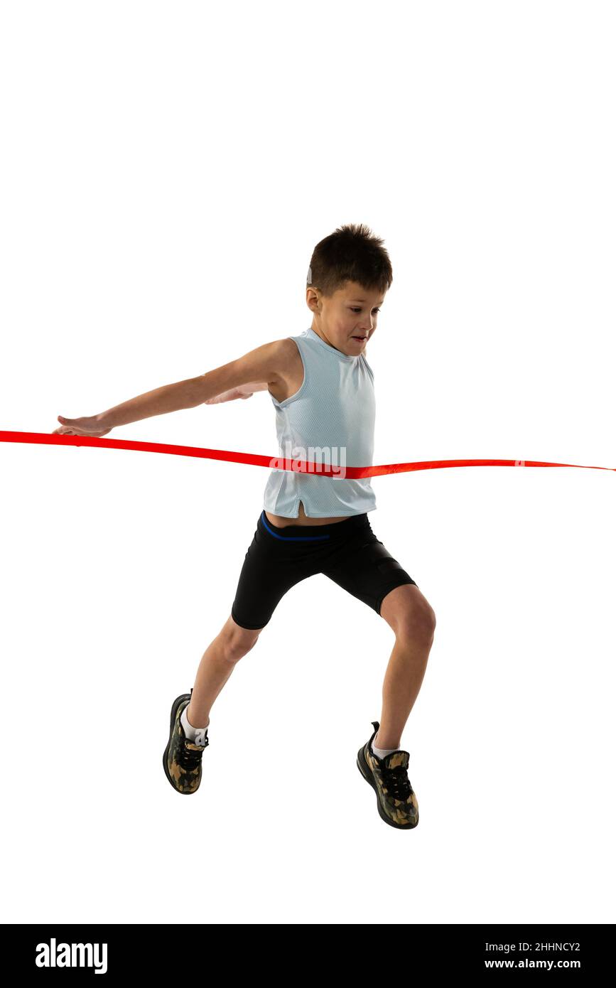 Full-lengfth studio shot of boy, teen running, crossing red line ...