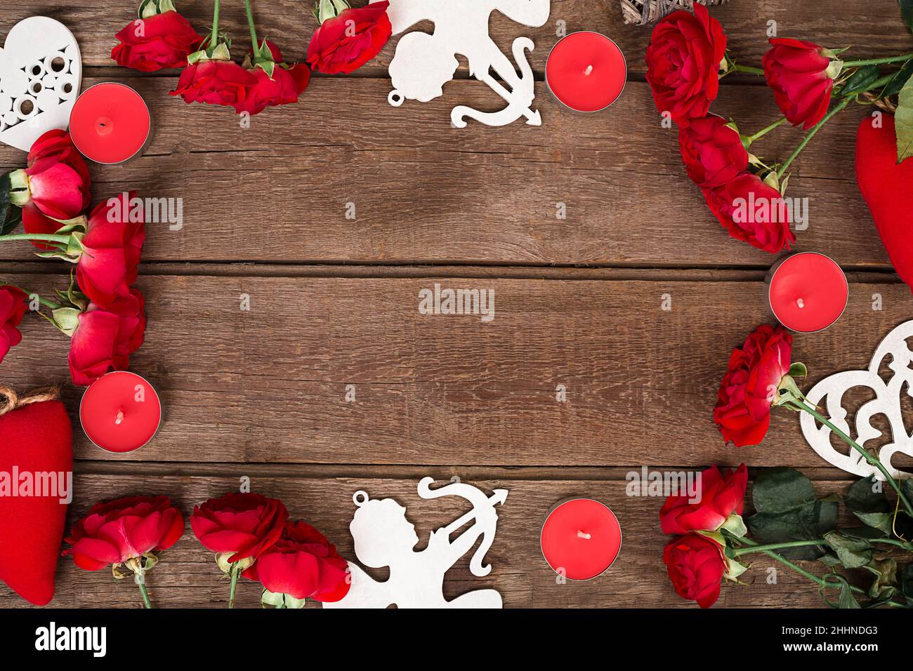 Red roses, candles and hearts over wood with copy space. Valentines day ...