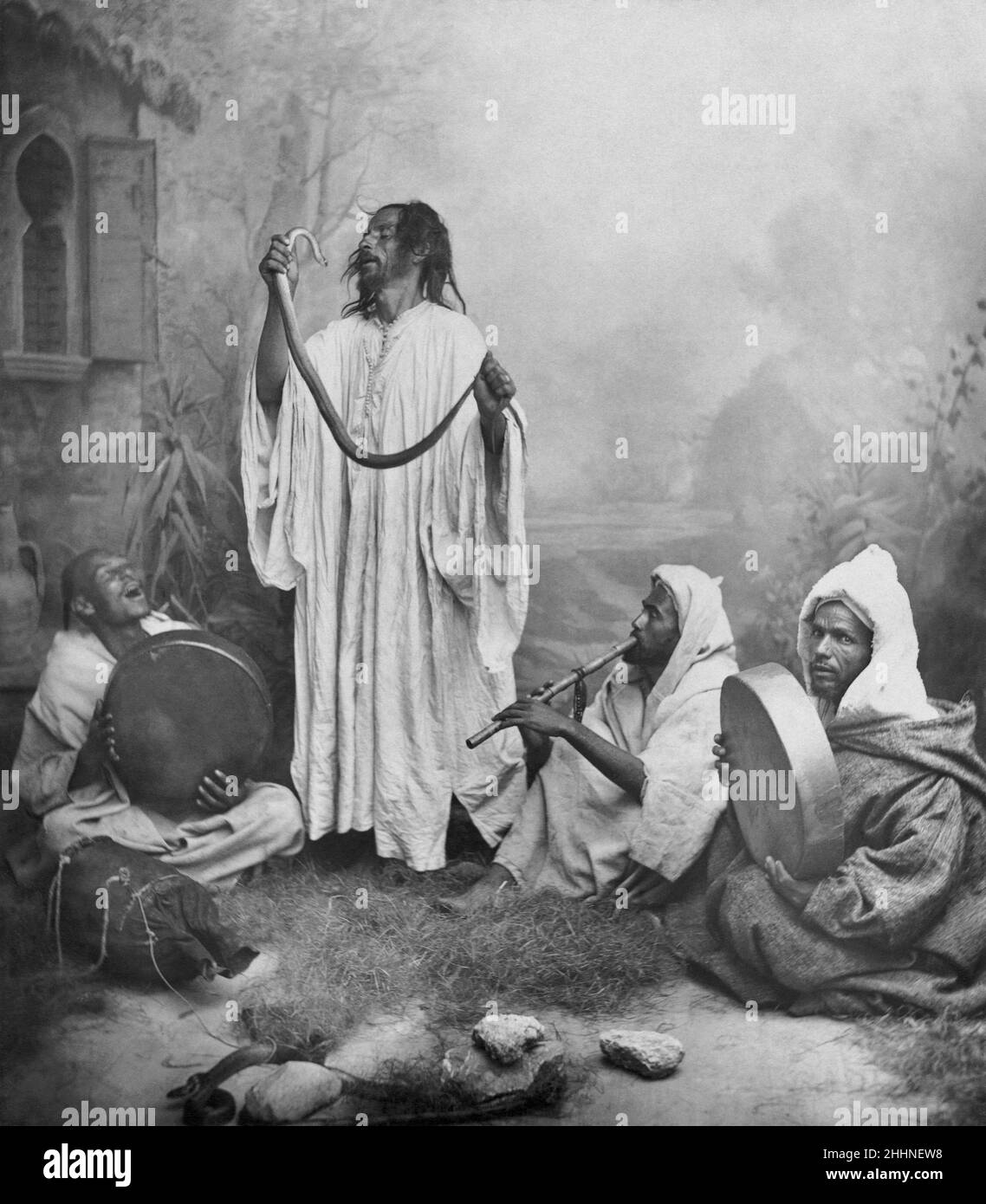 Snake Charmer - Tancrède Dumas - Moroccan man holds a snake standing ...