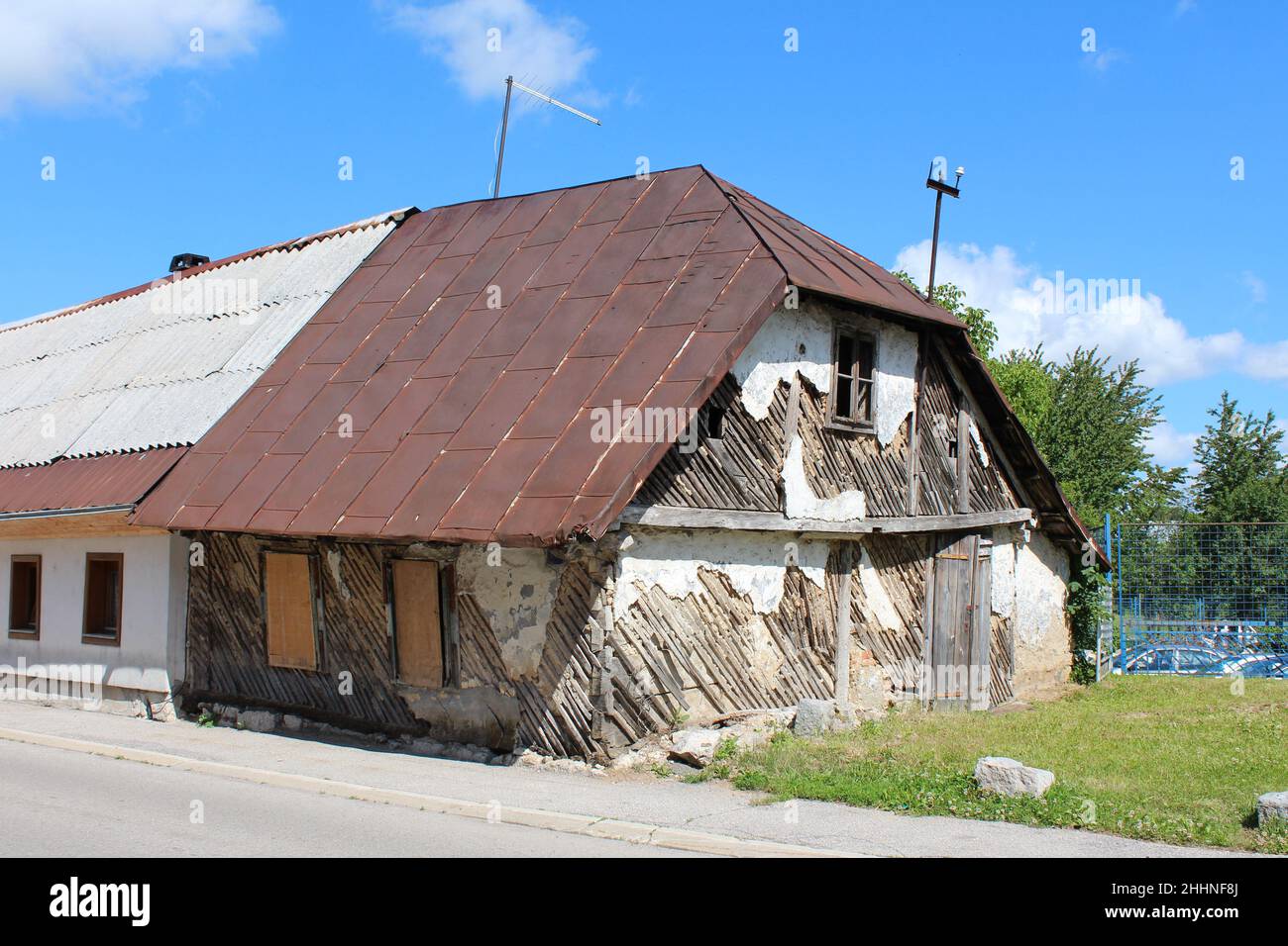 Tiny old very small abandoned attached suburban family house made from wood and clay natural ...