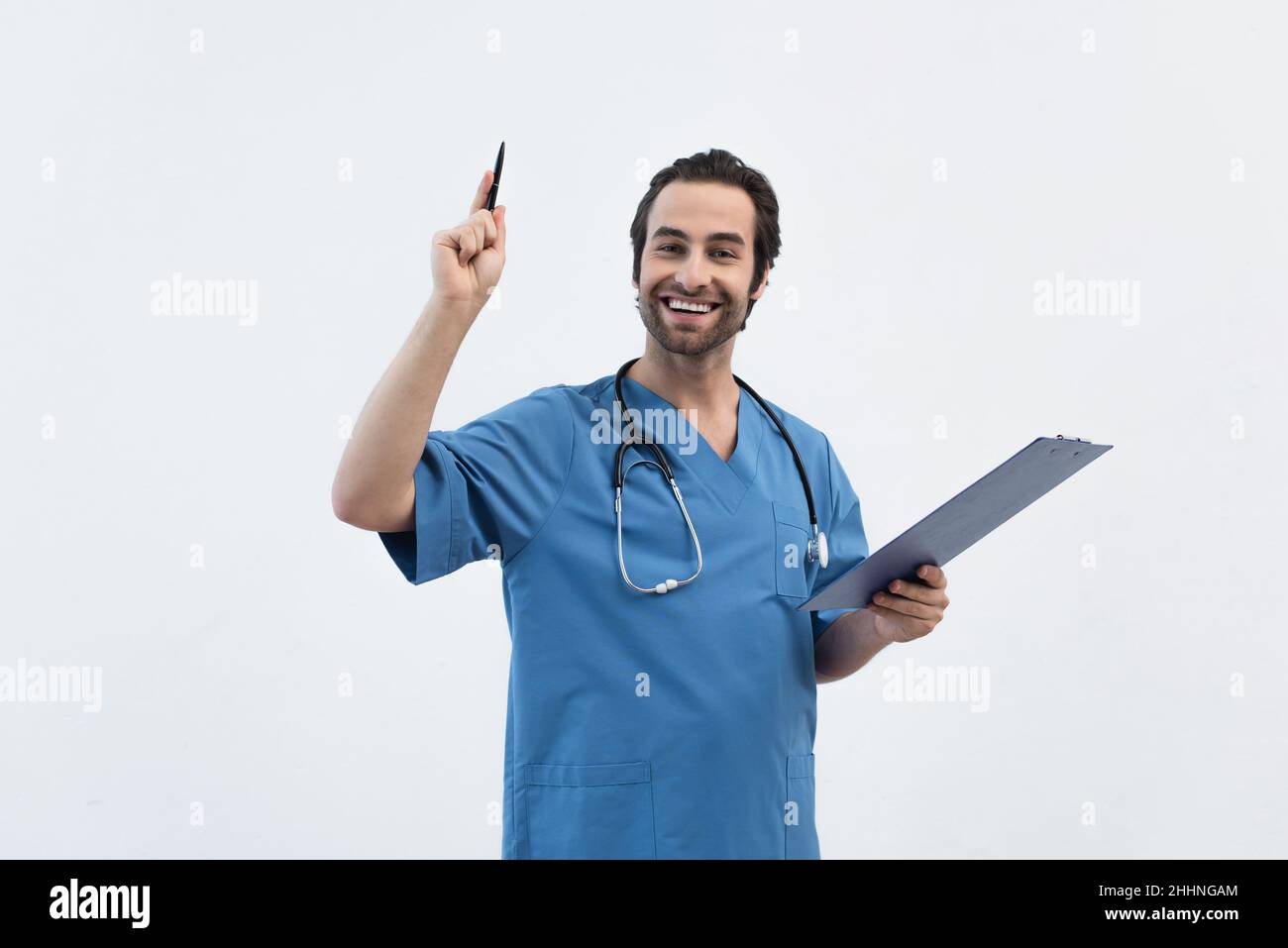 happy doctor with clipboard pointing up with pen isolated on grey Stock ...