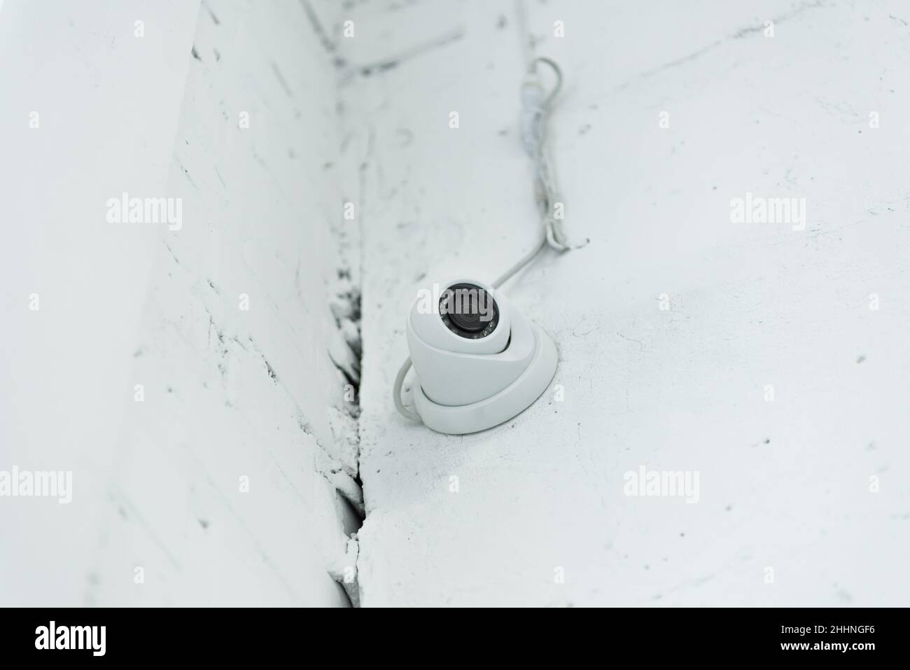 low angle view of supervision camera on white wall Stock Photo - Alamy