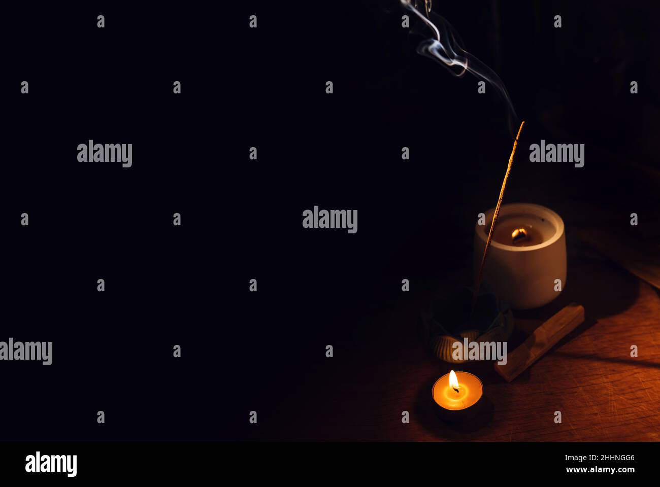 Incense aroma sticks smoldering on table lotus holder and candle in ...