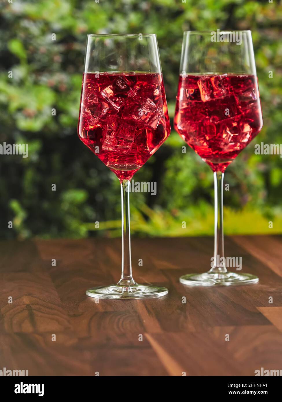 Apple cider with red berry flavor in a garden setting, bottom copy ...