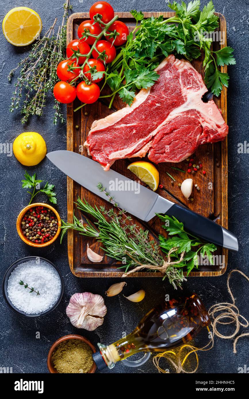 porterhouse beef steak with herbs, spices. beef steak on a rustic ...
